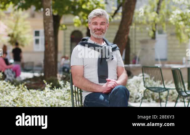 Happy mature man tourist smiling friendly at camera, waving hands ...