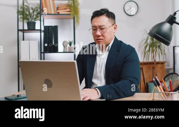 Tired Asian businessman feeling worried about financial problem stress ...