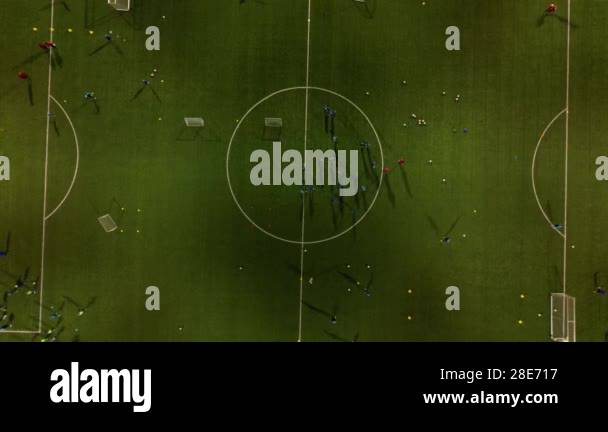 football training on an illuminated stadium in the evening. children ...