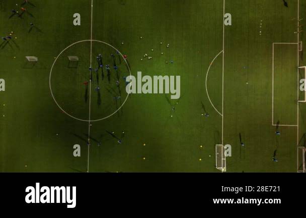 football training on an illuminated stadium in the evening. children ...