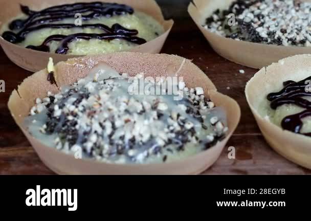 Asian Indonesia man hand cooking street food terang bulan with nuts ...
