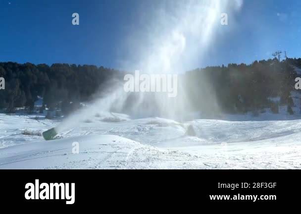 Snowmaking machine. Snow cannon, fan-type snow generator works at a ski ...