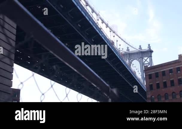 New York City Manhattan Bridge in Dumbo, Brooklyn. Red brick building on Plymouth street near ...