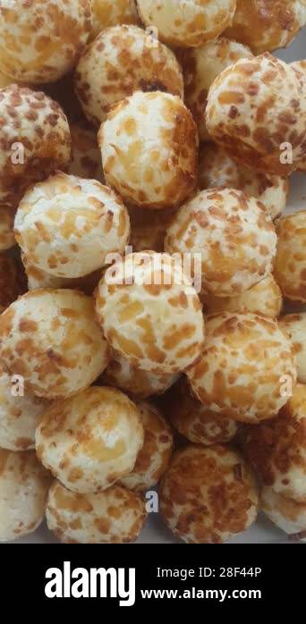 Small Brazilian cheese breads steaming inside a glass display of a ...