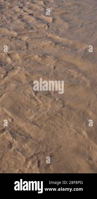 Strong flow of water and mud on a riverbed, in slow motion Stock Video ...