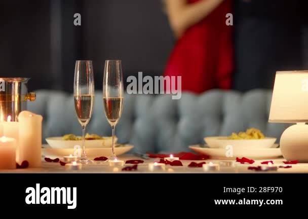 A diverse, young couple enjoys an intimate dinner at a restaurant ...