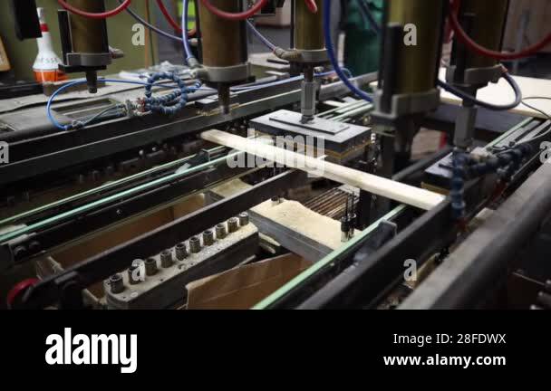 Industrial factory setup featuring automated machinery with metal arms ...