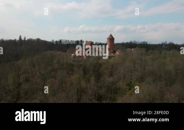 Medieval style red brick castle with a cylindrical tower, pitched roof ...