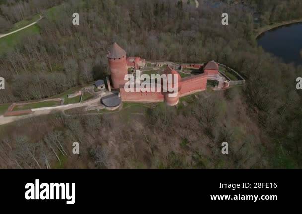 Medieval red brick castle with cylindrical and multiple towers ...