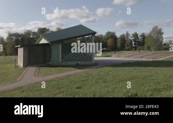 Open seating area with wooden benches, picnic tables under red roofed ...