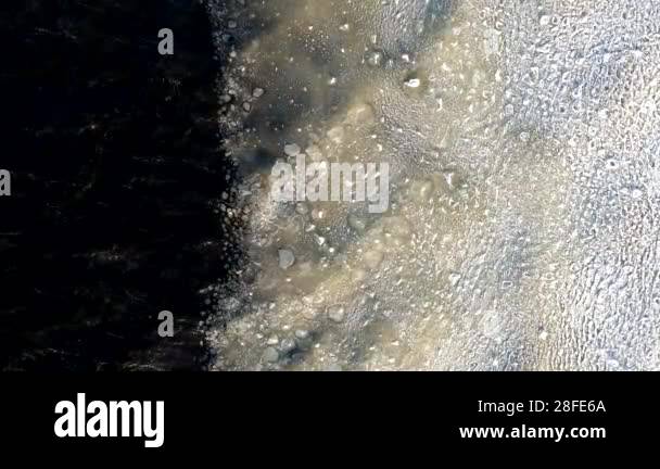 An aerial perspective of dark flowing water contrasting with a lighter ...