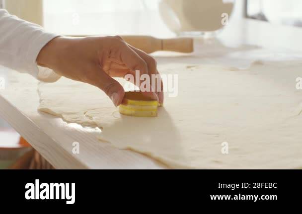 In a warm, inviting kitchen, a young African American woman is ...