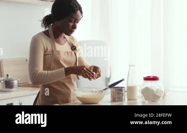 African American woman mother mixing ingredients for a delicious treat ...