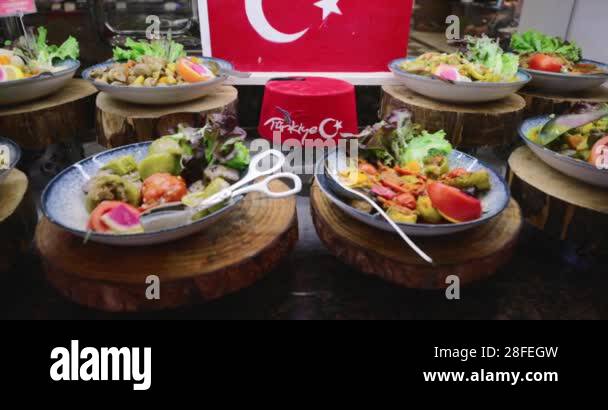 An array of Turkish dishes on wooden platforms, featuring meats ...
