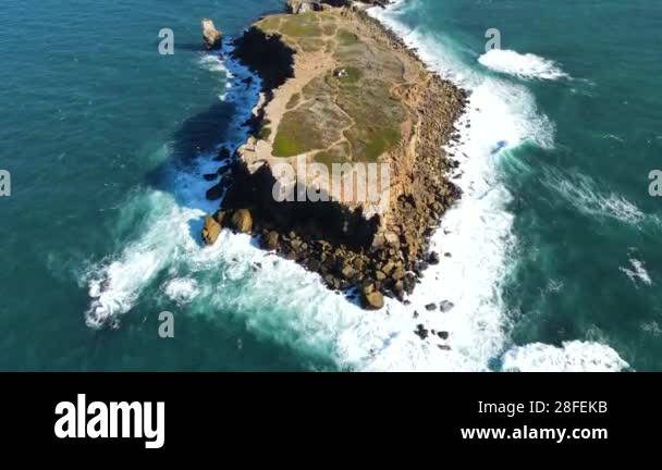 The rocky peninsula of Portugal extends into the Atlantic Ocean ...