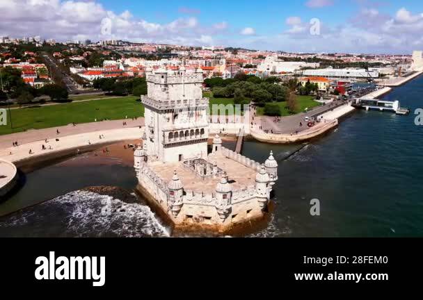 Belem Tower stands on the Tagus River with Lisbon's cityscape and the ...