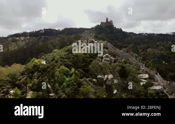 Pena Palace's vibrant red and yellow hues contrast with the cloudy sky ...