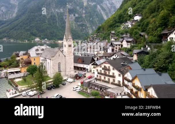Hallstatt in Austria features the Evangelical Church spire, traditional ...