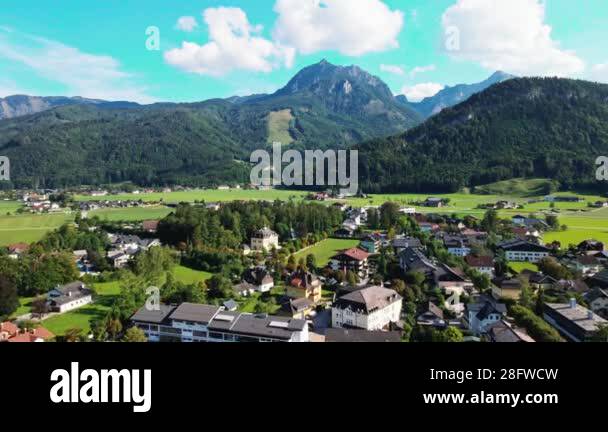 A charming Austrian village features sloped roof houses, expansive ...