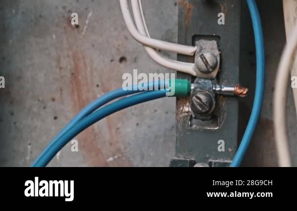 Close view of wiring terminals in an open electrical box featuring ...