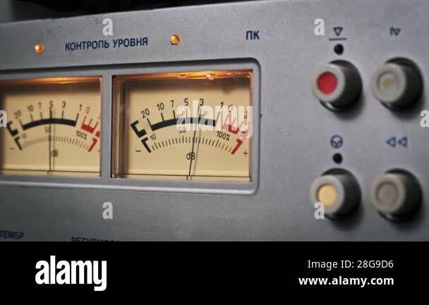 Close-up of a vintage VU meter in operation, needles moving ...