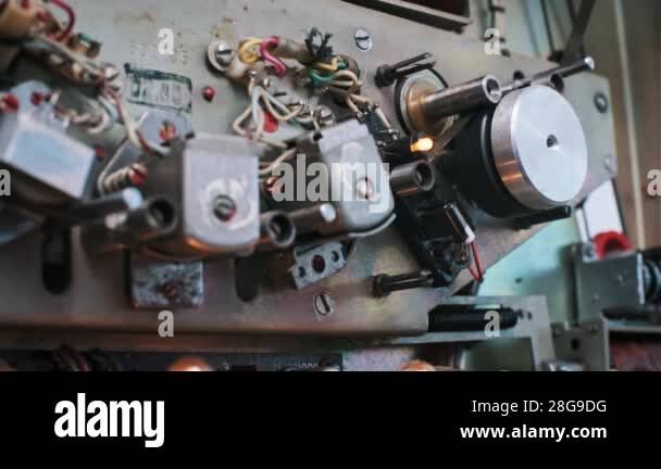 Intricate mechanism of a retro reel-to-reel tape recorder in motion ...