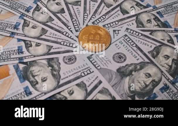 A gold Bitcoin coin is surrounded by a circular pattern of one hundred ...