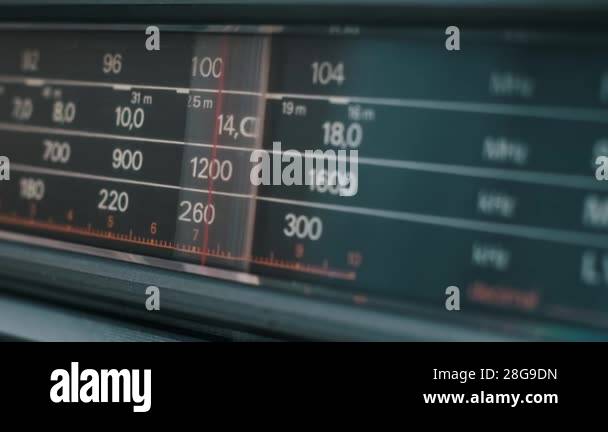 A detailed view of the radio tuner on a classic audio deck. The red ...