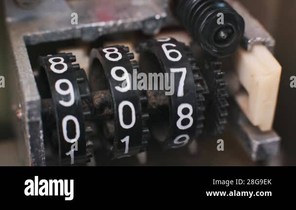 The digits on a vintage mechanical counter spin and increment, showing ...