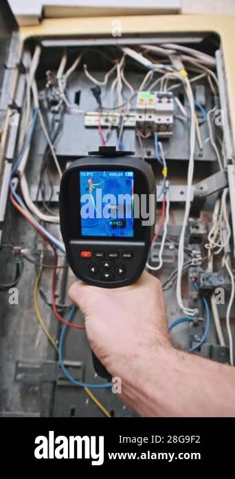 Close-up of an open electrical panel being scanned with a thermal ...