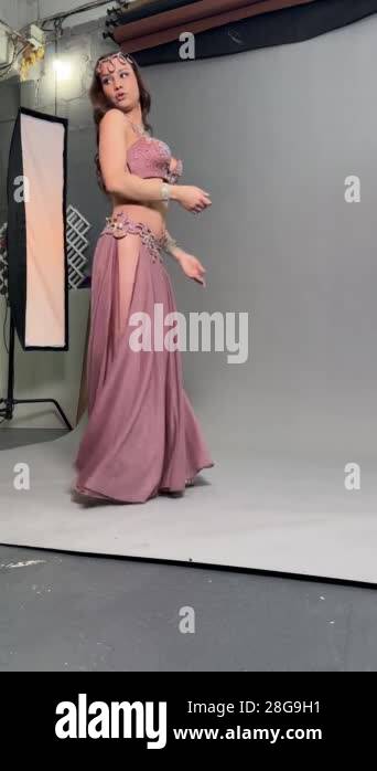 A talented woman performs a captivating belly dance routine in a well ...