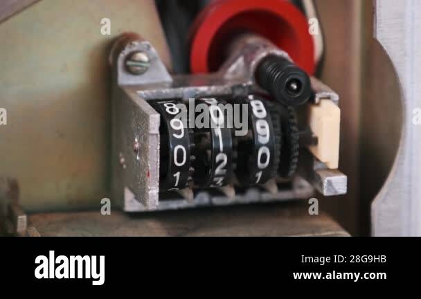 Close-up of a mechanical counter with black numbered wheels, showcasing ...