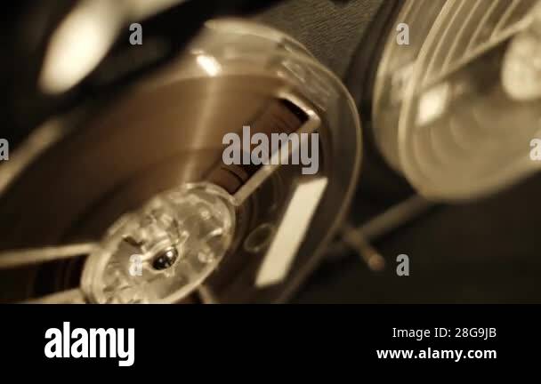 Close up showcasing a reel to reel tape recorder with clear moving ...