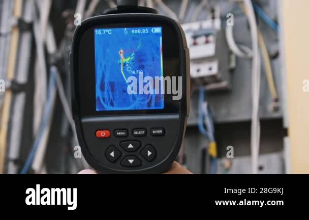 A handheld thermal camera captures detailed temperature variations on ...