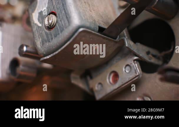 A close-up showing tape moving through the playback head of a vintage ...