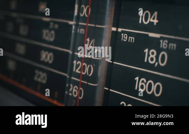 Close-up of a radio dial as the needle moves across frequencies. The ...