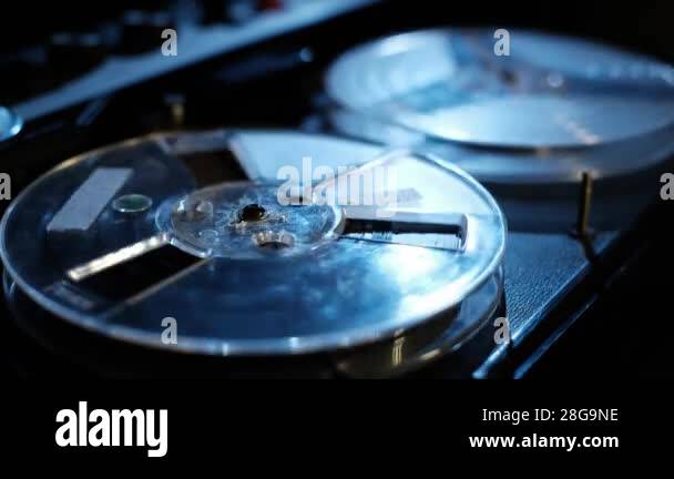 This close-up shot shows the reels of a vintage reel-to-reel tape ...