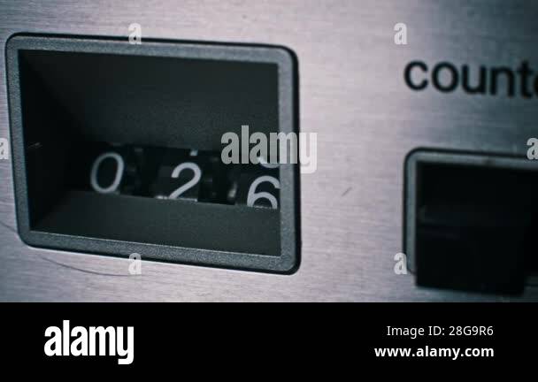 Macro shot of a mechanical counter advancing, showing the digits ...