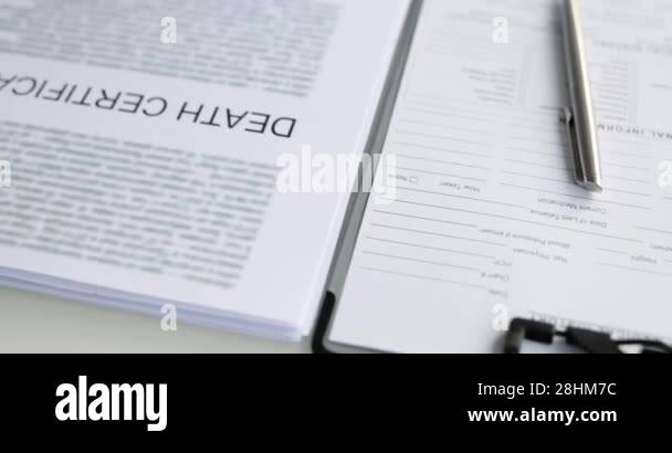 A closeup photograph of a death certificate document placed neatly ...