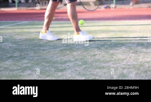 A players focused stance, preparing for a tennis shot on the court ...
