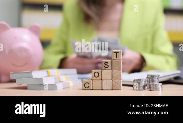 Word Cost from cubes in form of steps against woman counting dollar ...
