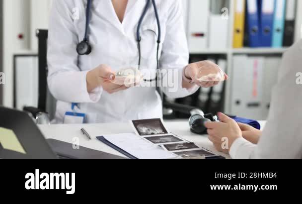 A healthcare professional carefully presents medical images and ...