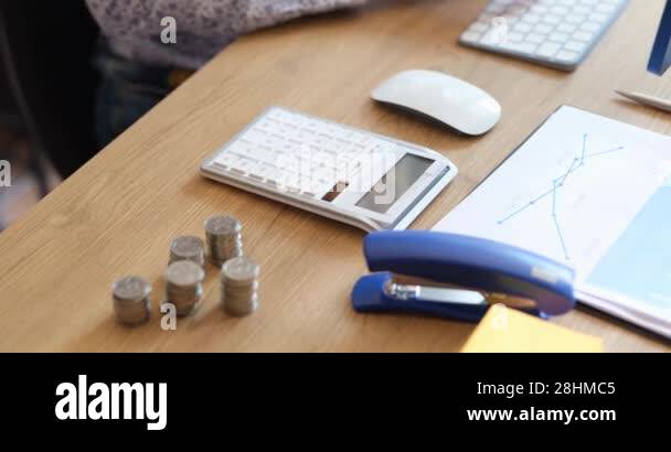 A clean office desk featuring a calculator, coins, and essential ...
