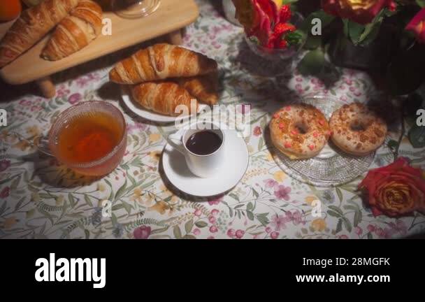 Hand Reaching For a Croissant Cup and Tea Cup. Floral Romantic Setup ...
