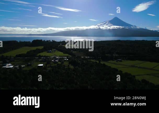 Witness the breathtaking beauty of a snow-capped volcano rising ...