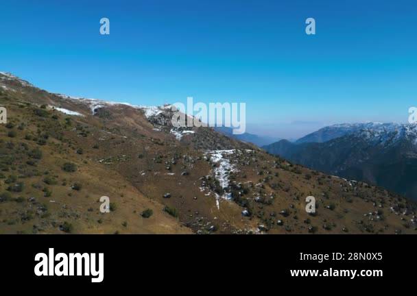 This aerial footage captures a stunning ascent along a rugged mountain ...