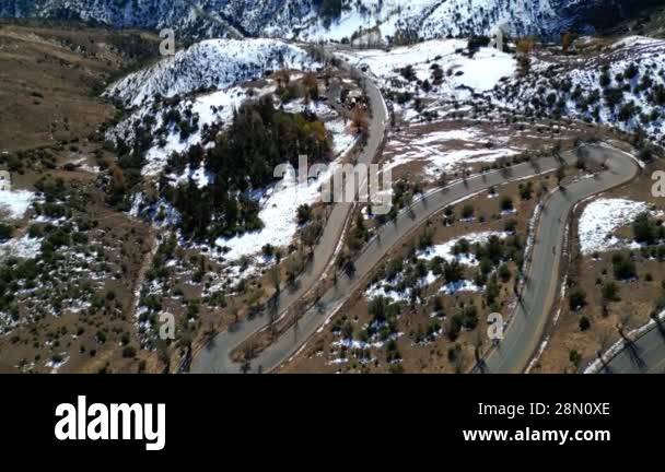 This stunning aerial footage captures a winding mountain road as the ...