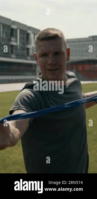 Medium vertical shot of young Caucasian para athlete with missing hand ...