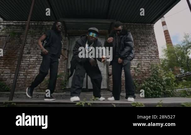 Full shot of cool African American man in glasses rapping and dancing ...