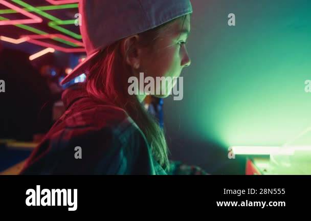 Side closeup of teenage Caucasian boy in baseball cap playing table ...